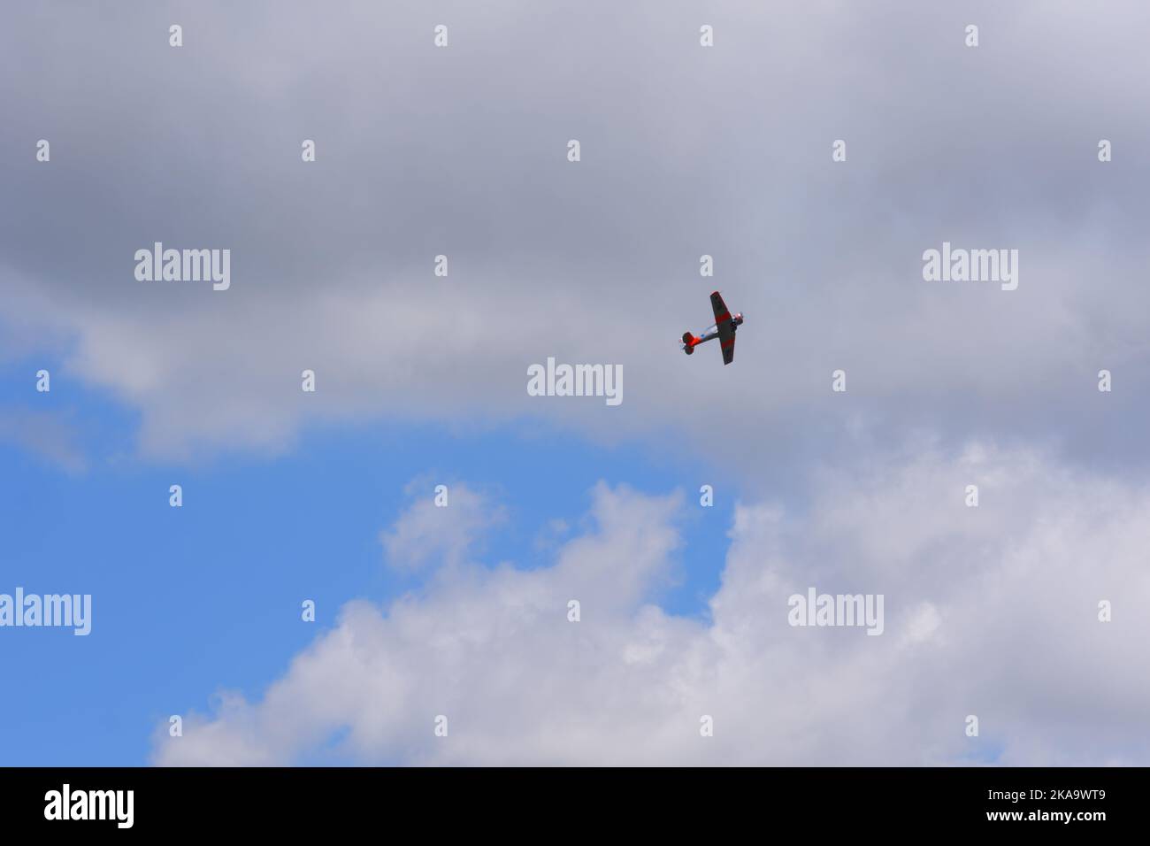 Plane flying within dark clouds with smoke on tail Stock Photo - Alamy