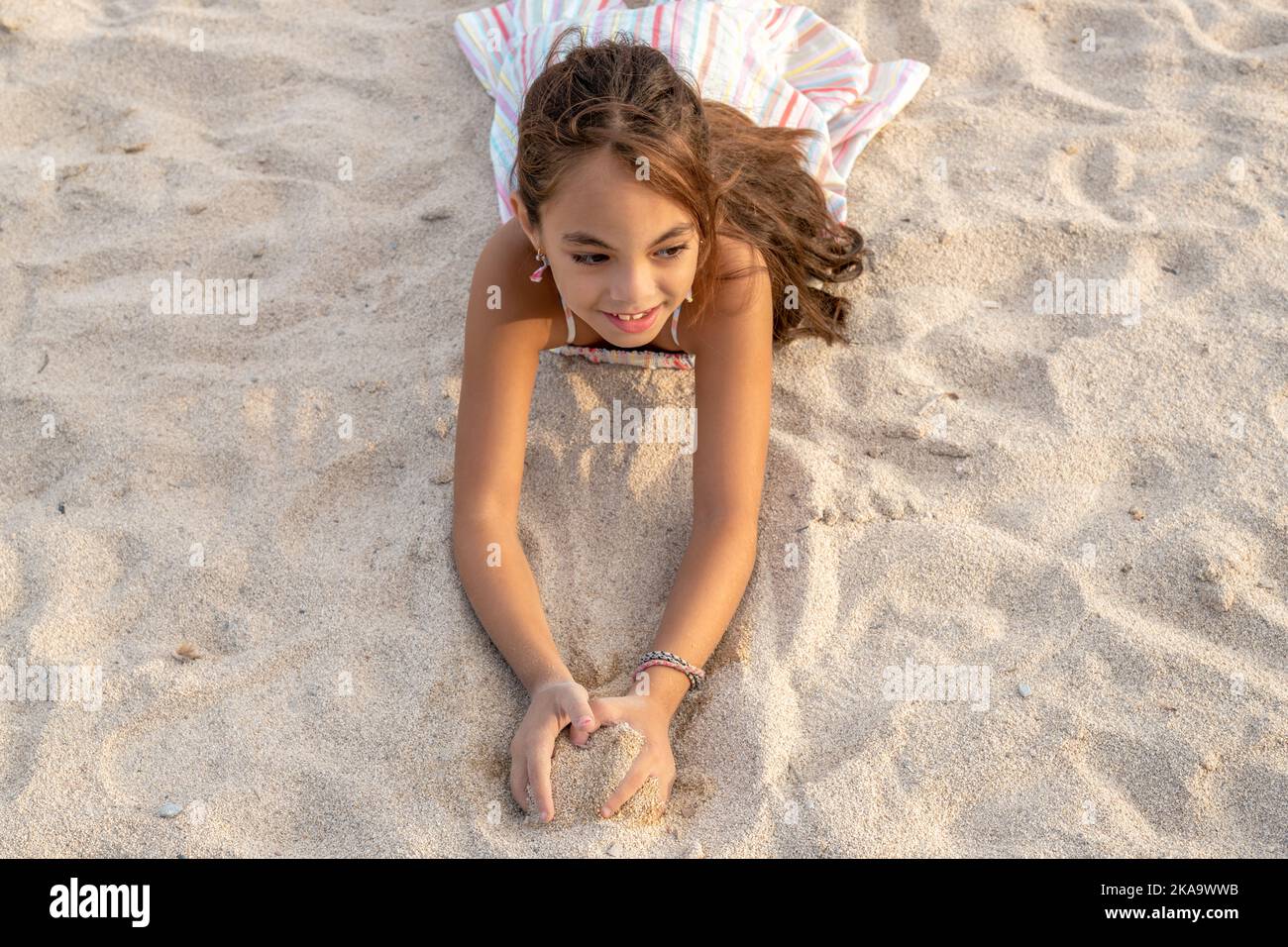 smiling cute little girl lying on the sand. child on vacation Stock ...