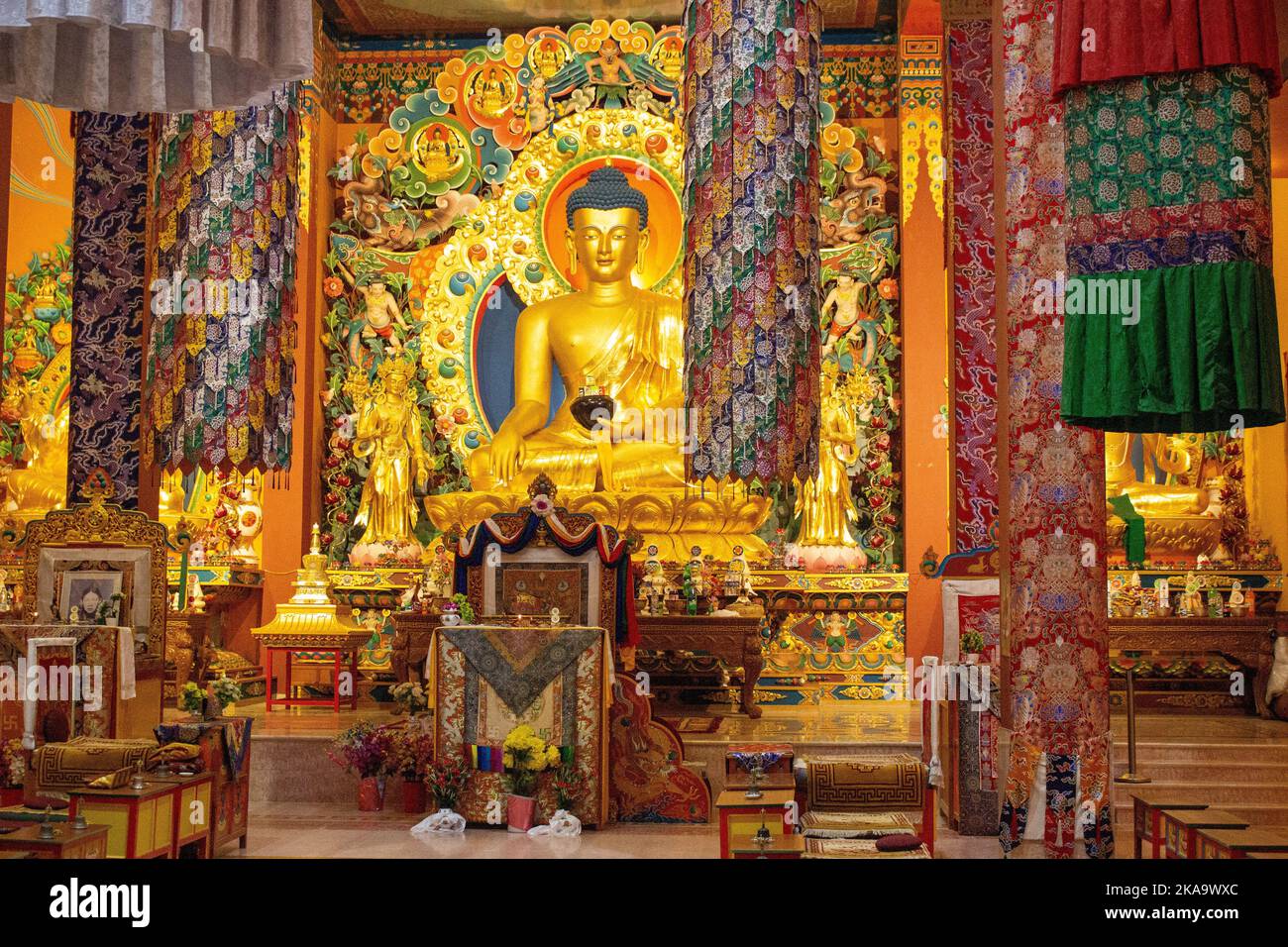 The beautiful interior of a Buddhist temple with an altar and colorful ...