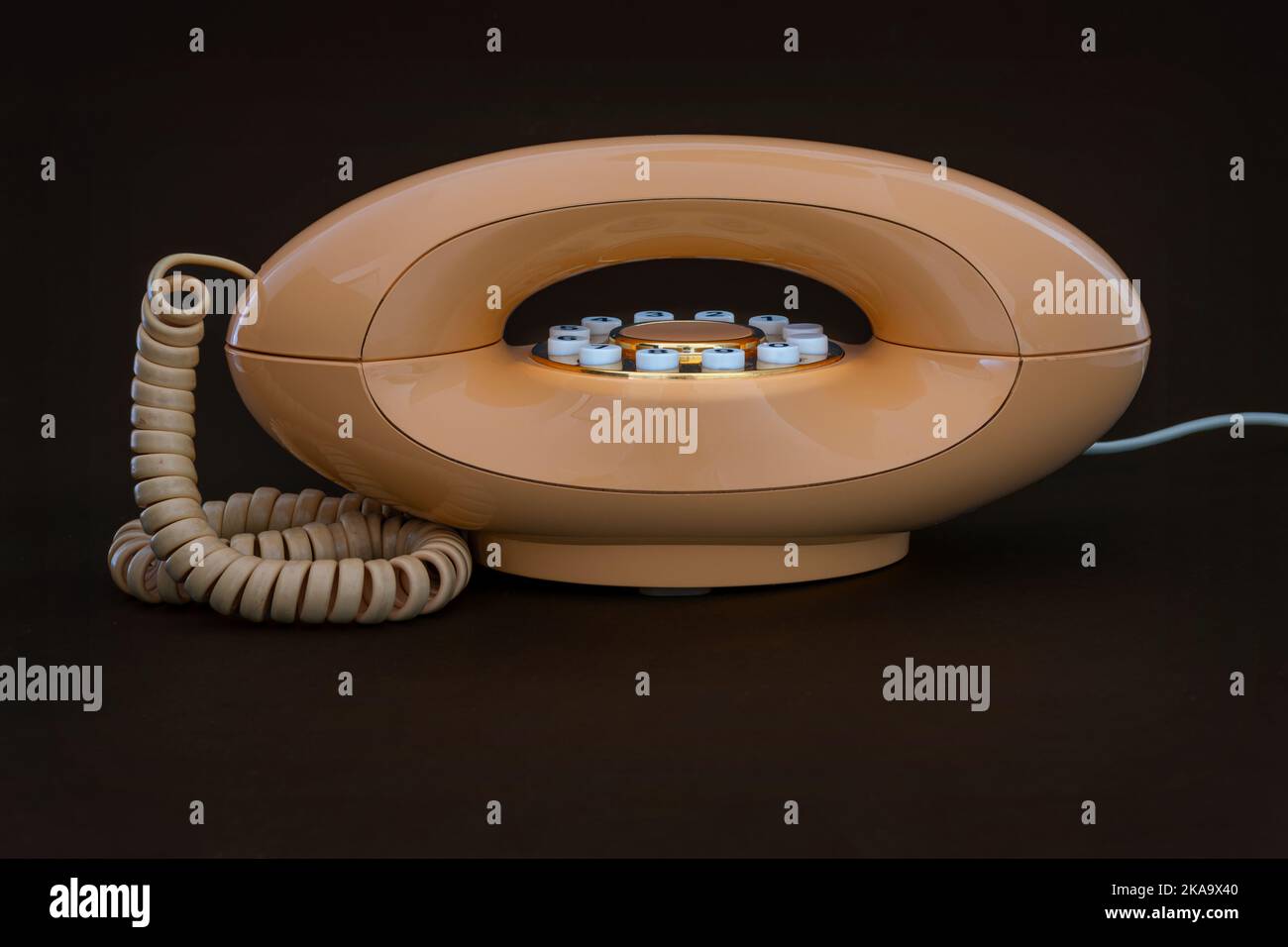 Peach coloured 1970's Modern telephone handset Stock Photo - Alamy