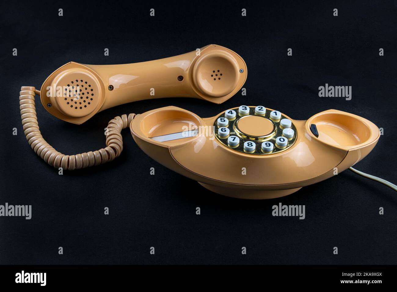 Peach coloured 1970's Modern telephone handset Stock Photo - Alamy
