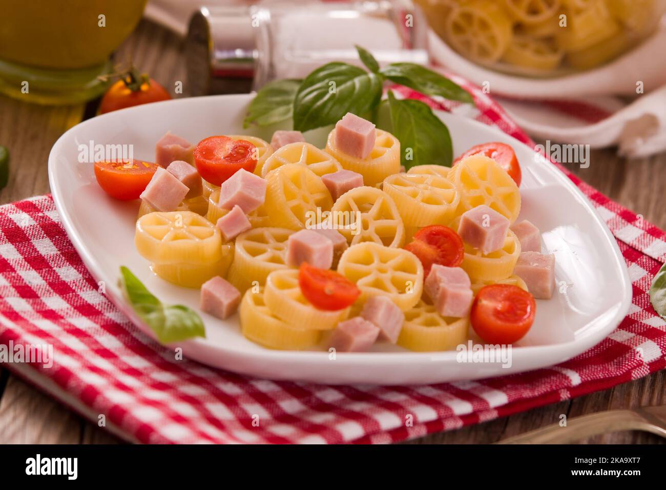 Ruote pasta with tomato and ham Stock Photo - Alamy