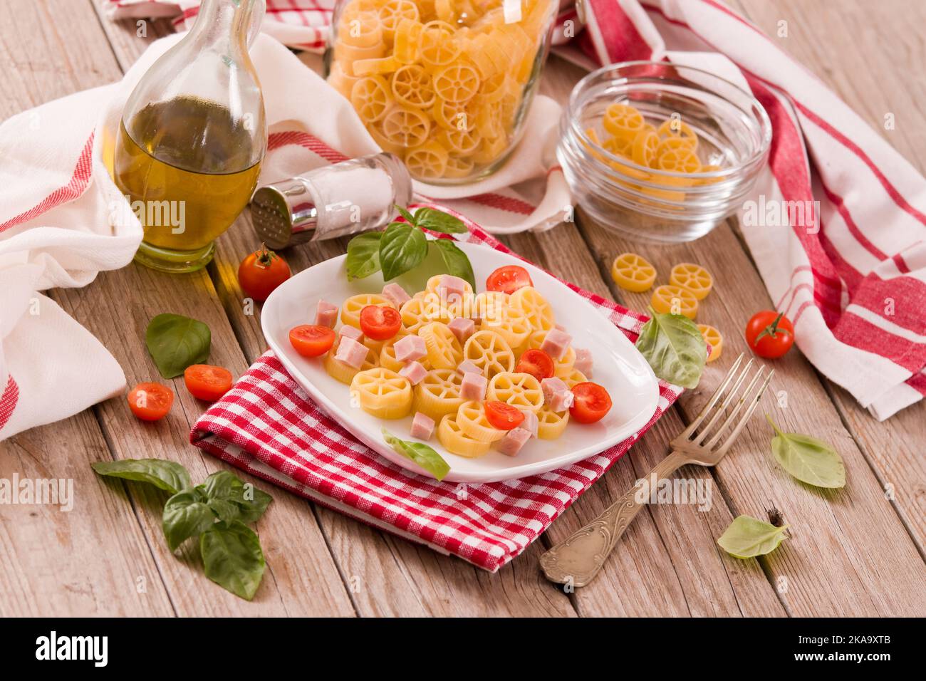 Ruote pasta with tomato and ham Stock Photo - Alamy