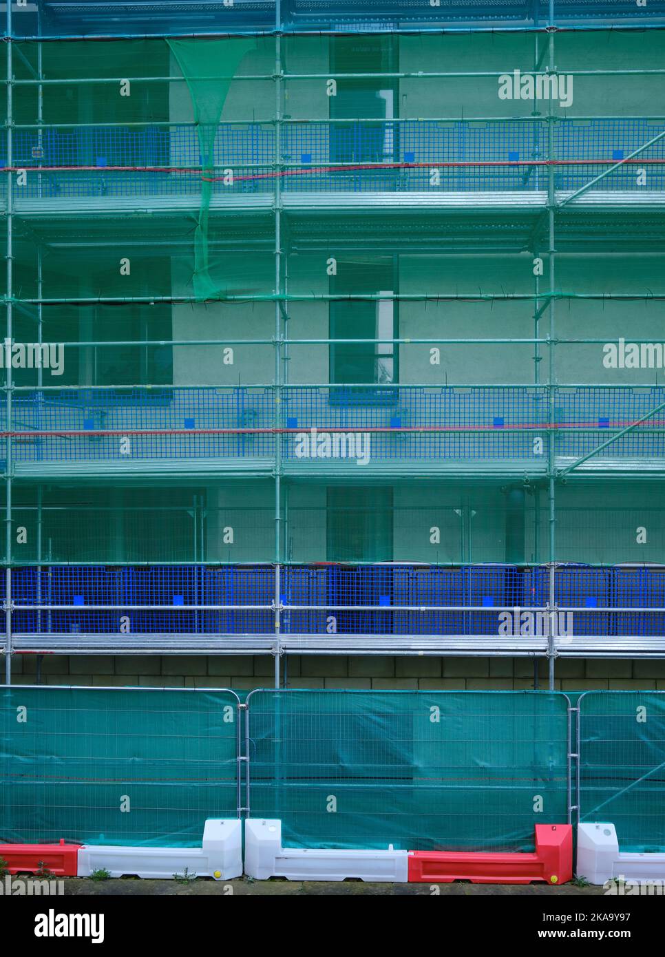 mesh-covered scaffolding during building restoration work Stock Photo ...