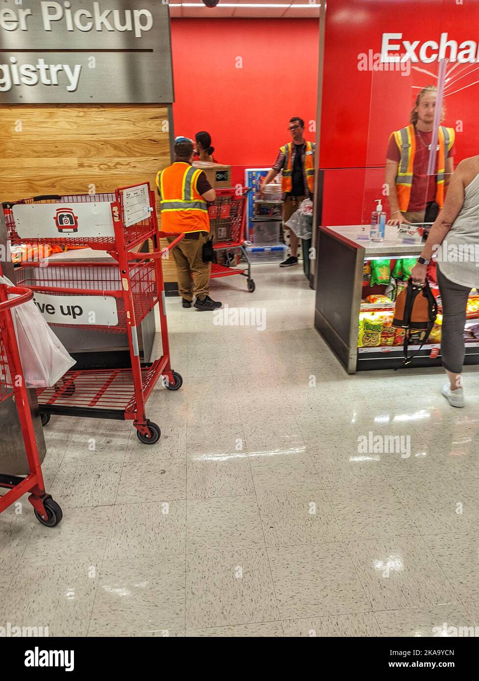 A vertical shot of people working at the return and exchange counter ...