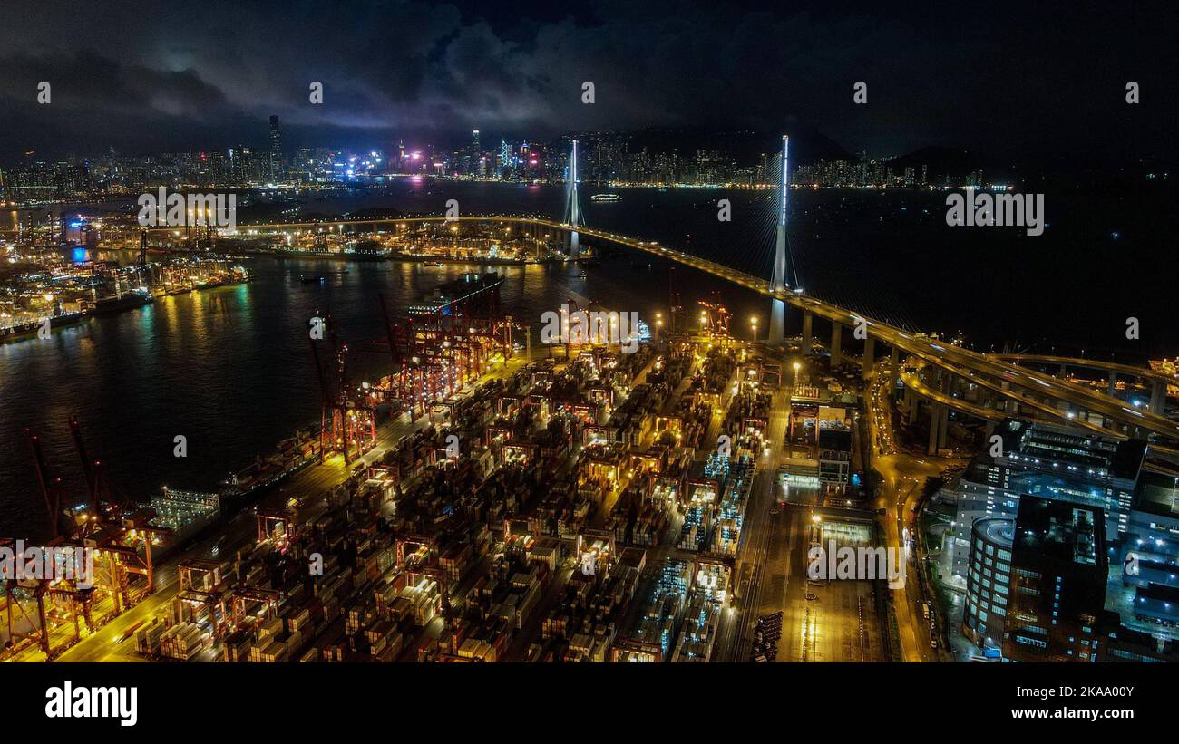 An aerial shot of dense coastline buildings with illuminated lights at ...