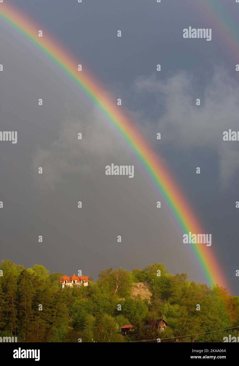 Part of a rainbow over a cloudy sky, syorm, light Stock Photo - Alamy