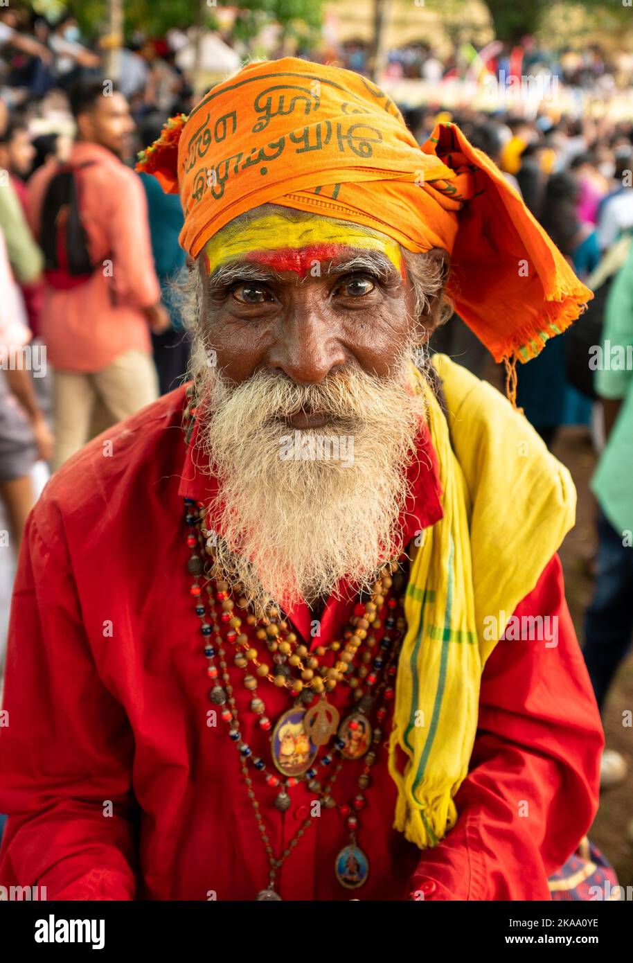 A vertical closeup portrait of a Hindu adult male in traditional ...