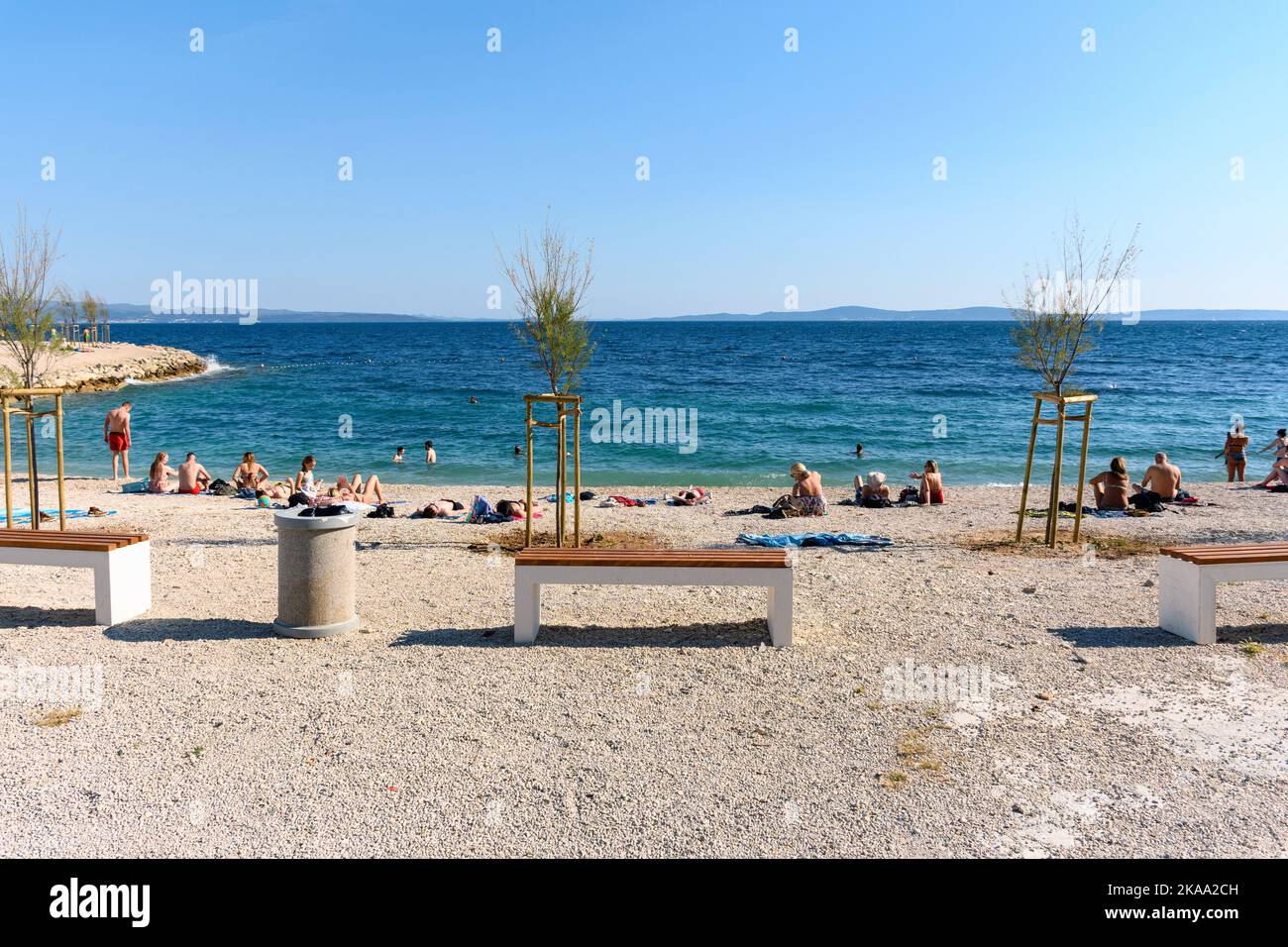 A beautiful view of people sunbathing and swimming on Jezinac beach at ...