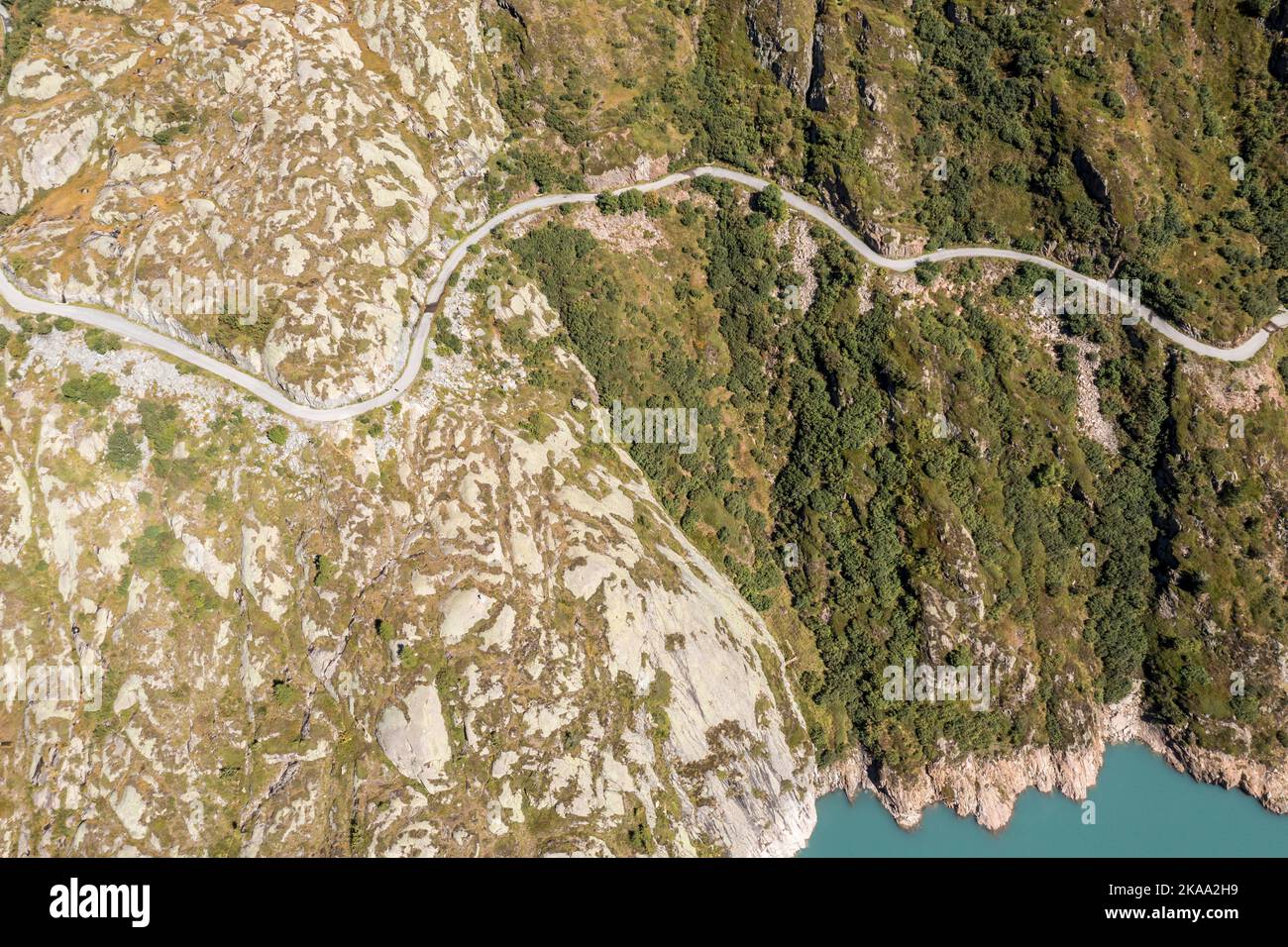 Aerial view over small road along east side of reservoir lake lac d' Emosson, Finhaut ...