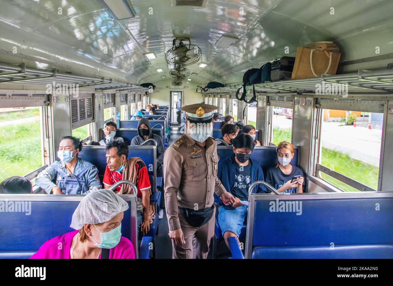 People and a conductor in a train wagon in Thailan Stock Photo - Alamy
