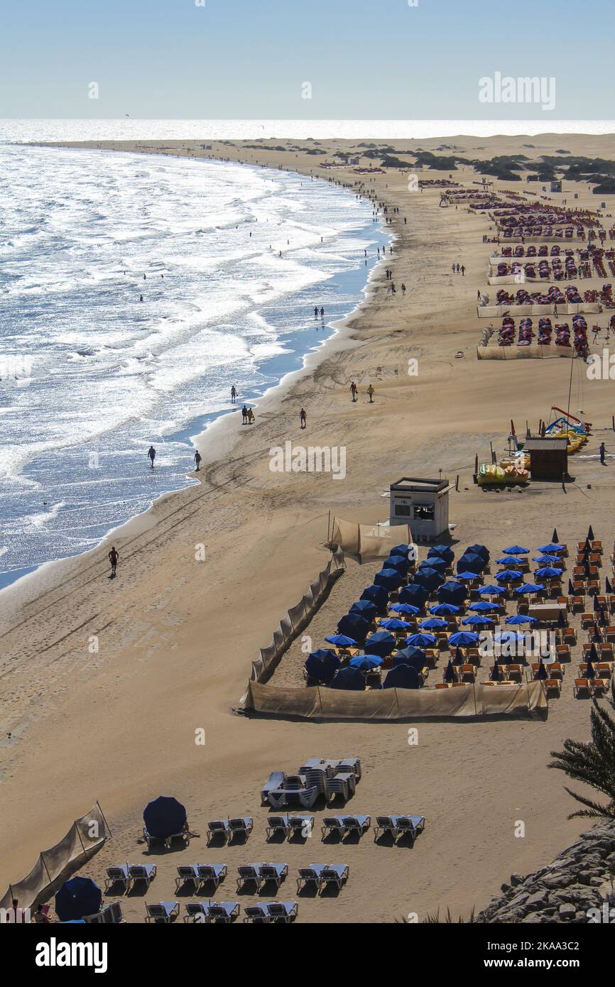 A view of a populated beach with people swimming and walking on Canary ...