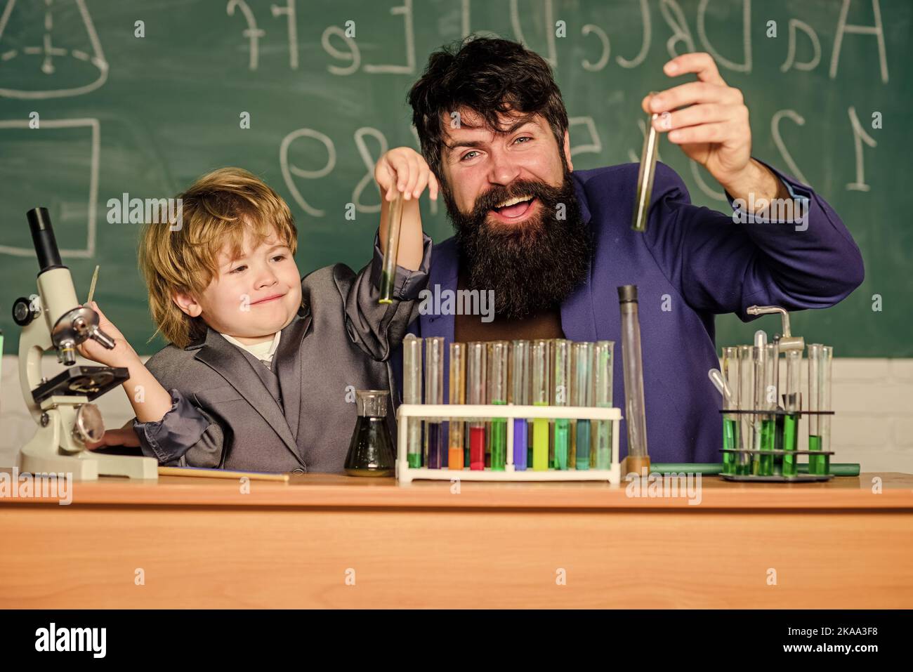 Back to school. Chemistry experiment. Teacher child test tubes ...