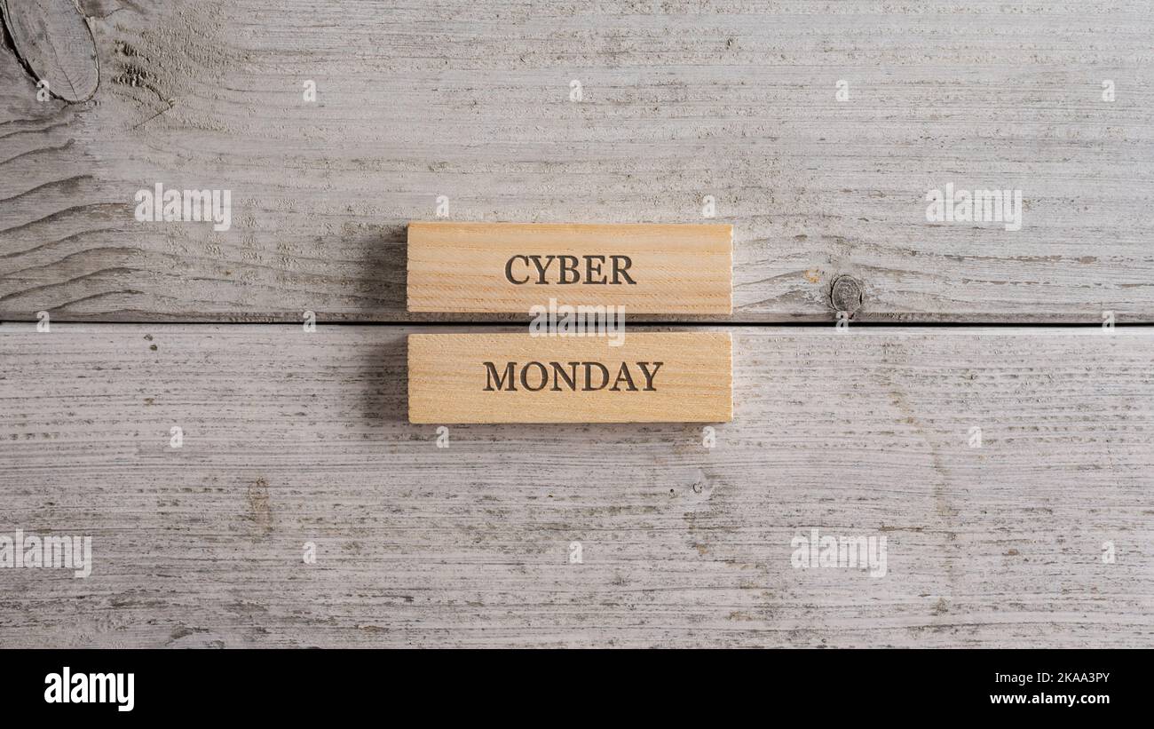 Cyber Monday sign written on two wooden pegs stacked over white ...