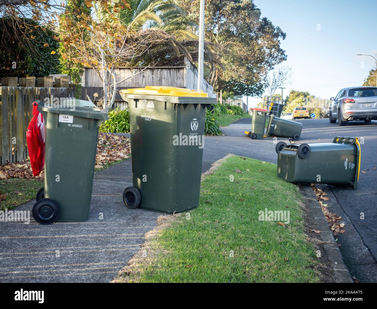 View Of Rubbish Wheelie Bins Toppled By Strong Wind Laying On Ground