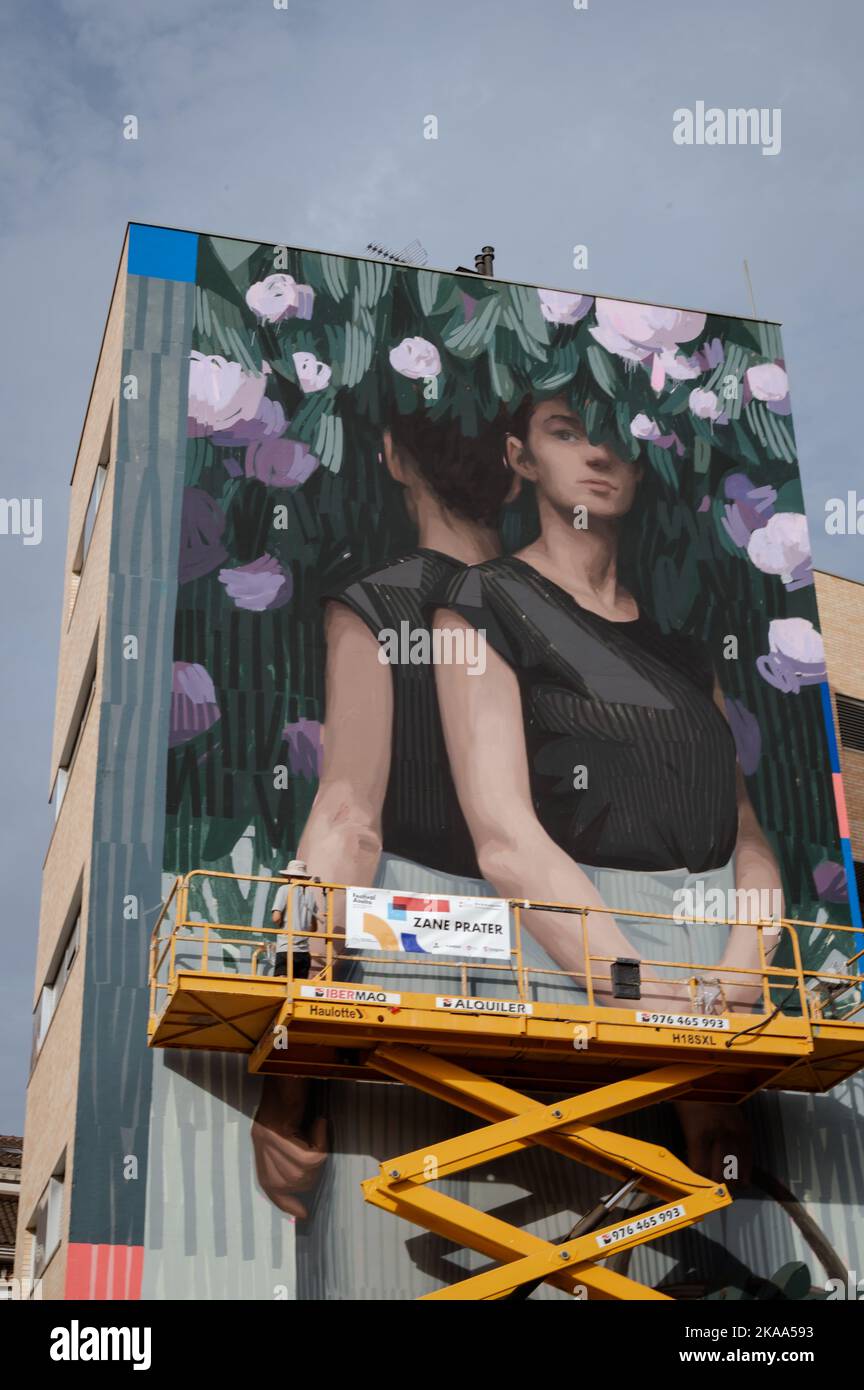 Artist Zane Prater paints a mural during Asalto International Urban Art ...