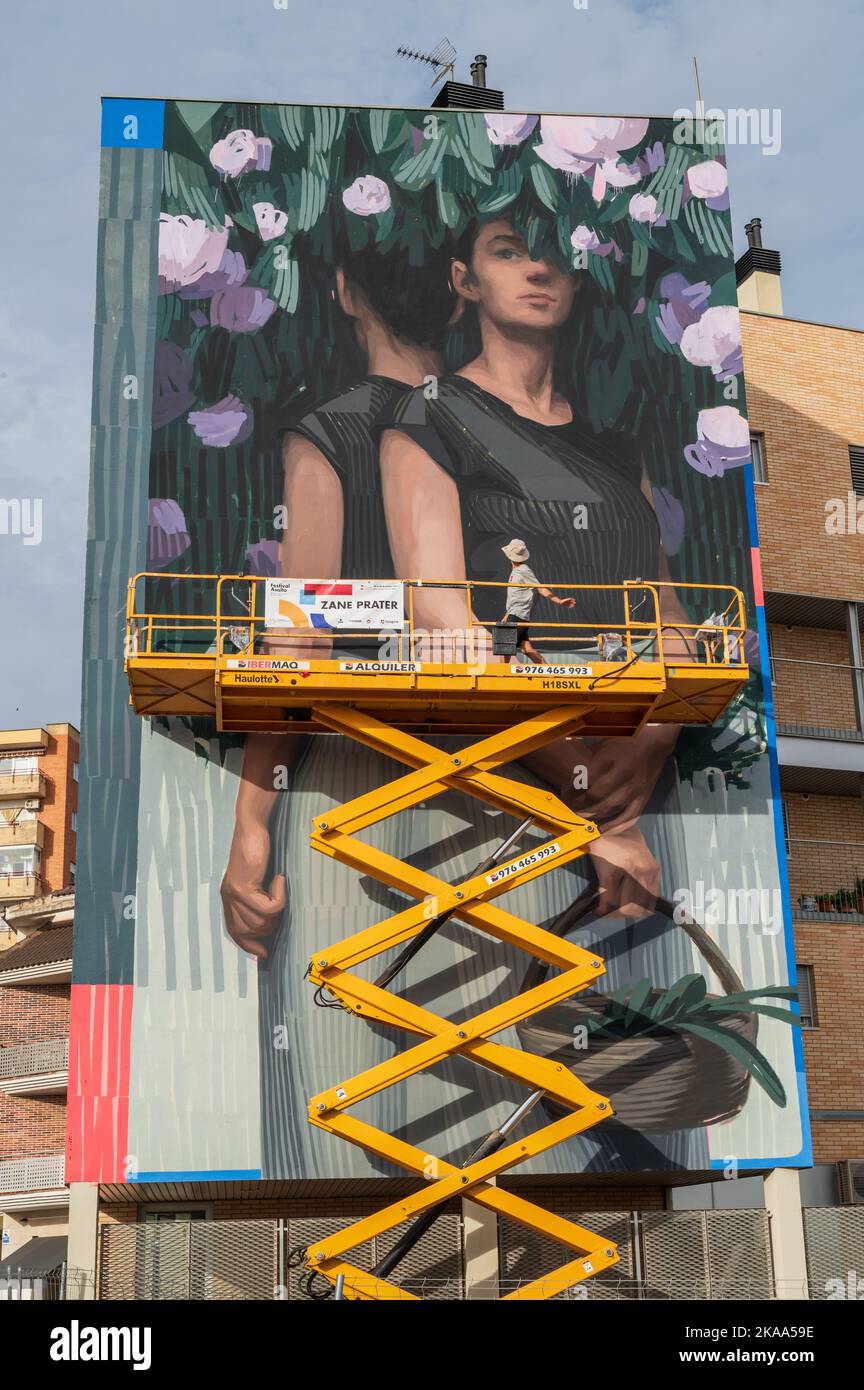 Artist Zane Prater paints a mural during Asalto International Urban Art ...