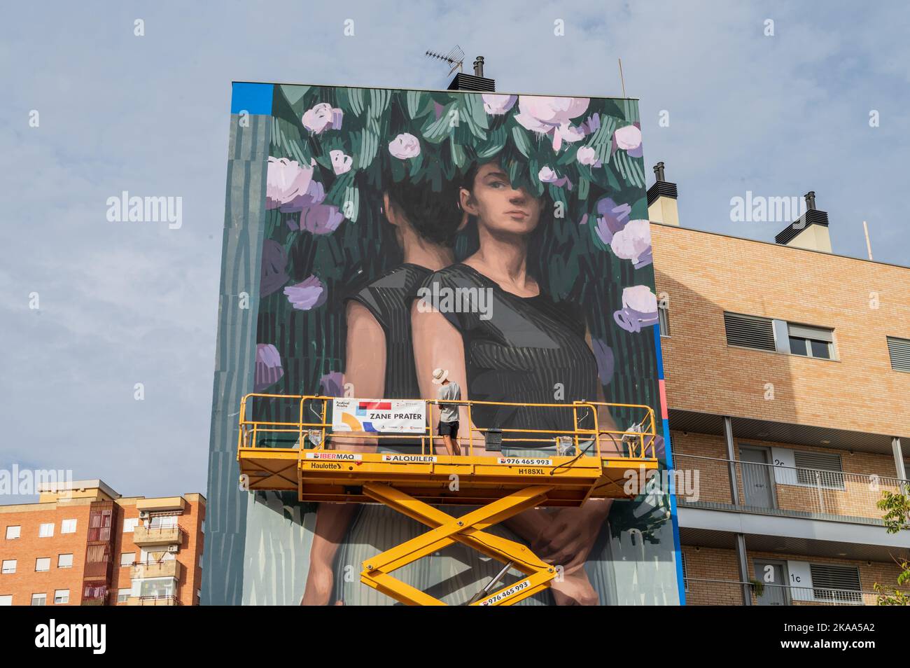 Artist Zane Prater paints a mural during Asalto International Urban Art ...