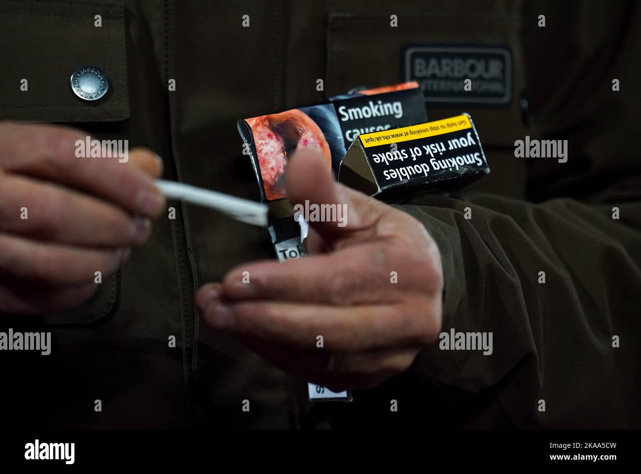 A Napoli fan rolls a cigarette during the UEFA Champions League Group A ...