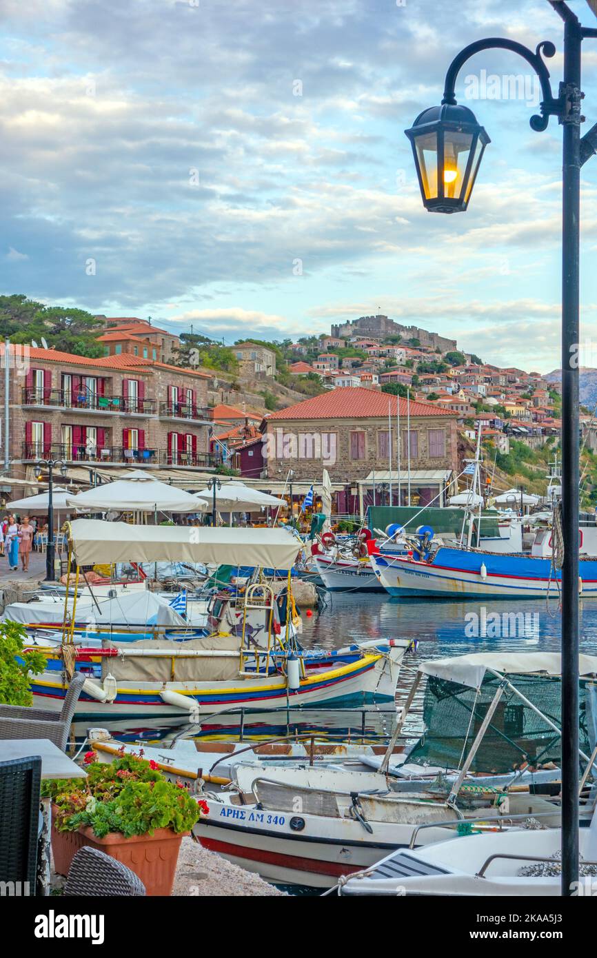 Cafes restaurants and bars along the harbour with boats moored at the ...