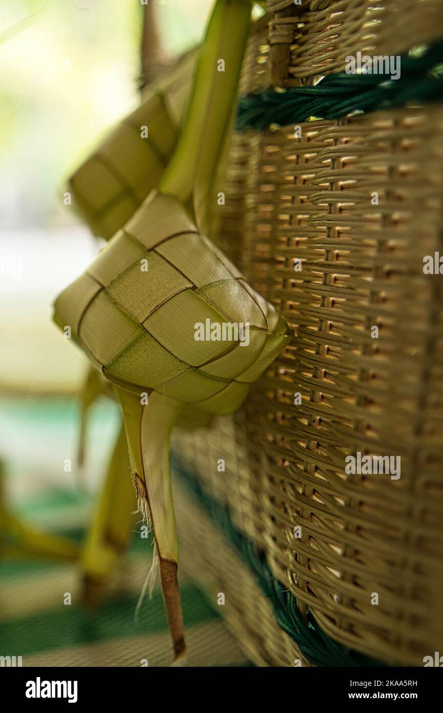 A closeup of a bunch of Ketupat - a rice cake made by weaving the ...