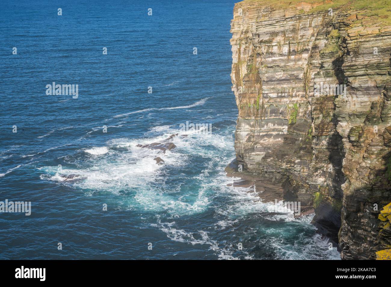 Rugged sea cliffs that guard the Kitchener memorial tower at Marwick ...