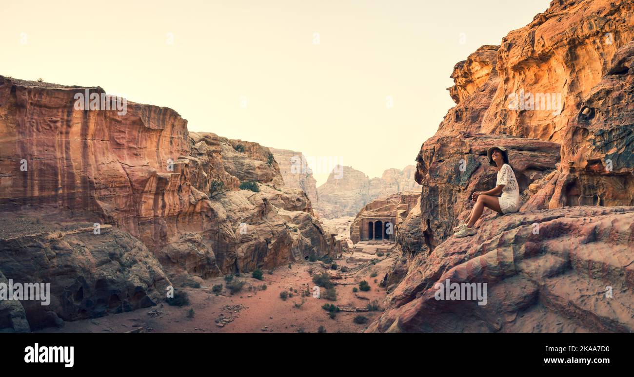 Caucasian young female tourist sit and smile while looking to beautiful ...