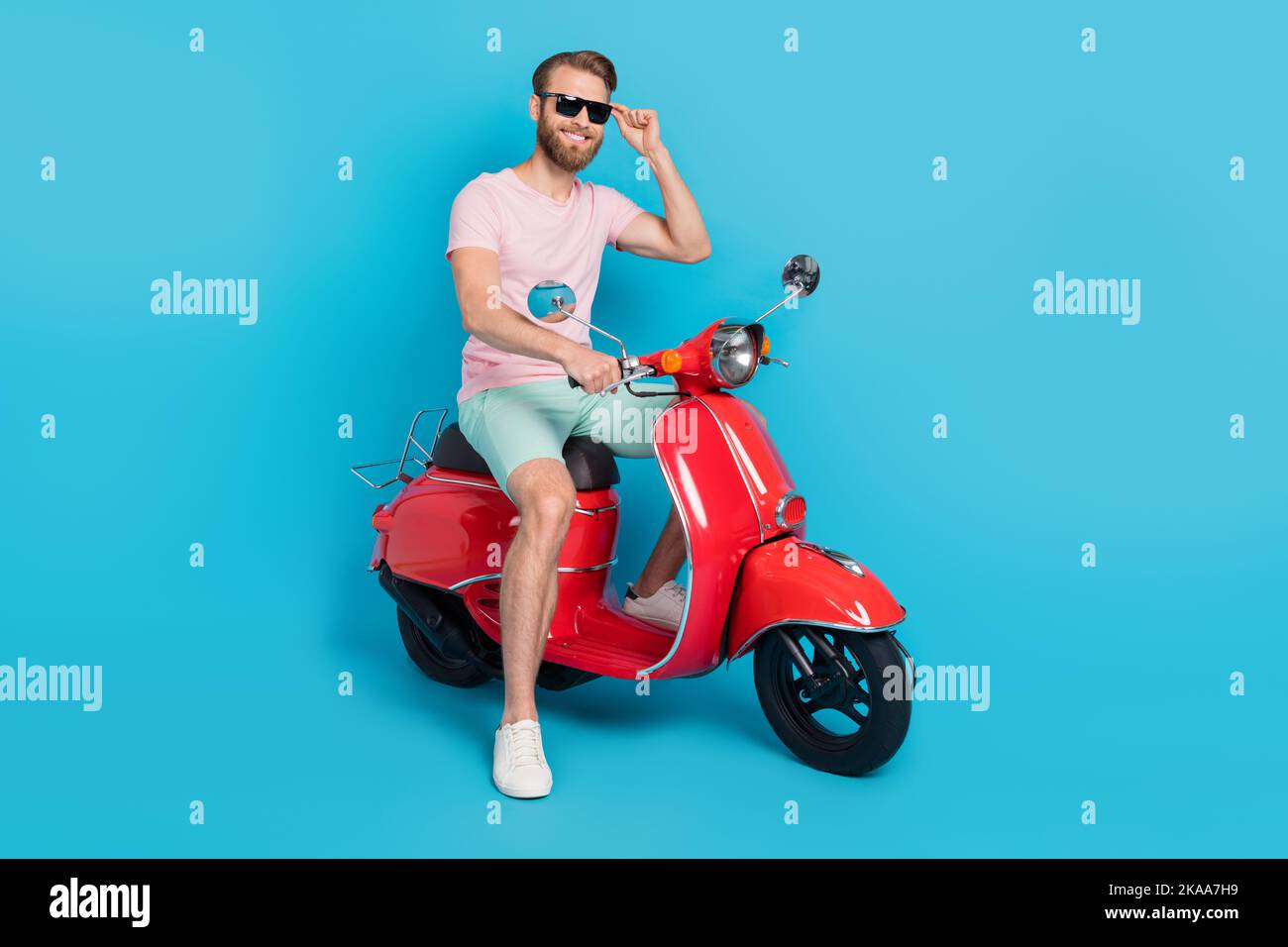 Full size photo of handsome young guy riding moped enjoy weekend ...