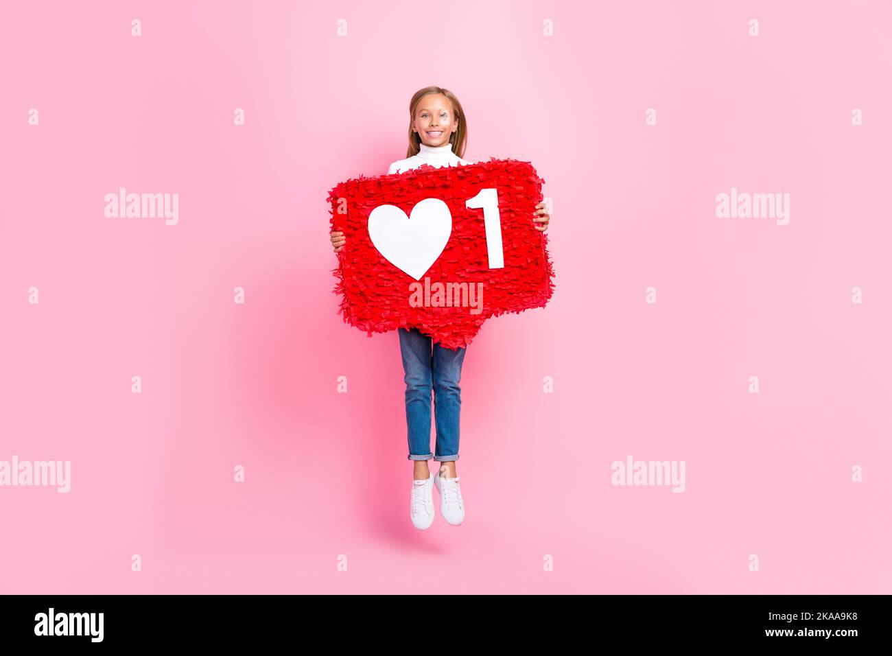 Full length photo of cheerful energetic girl jumping hands hold large ...