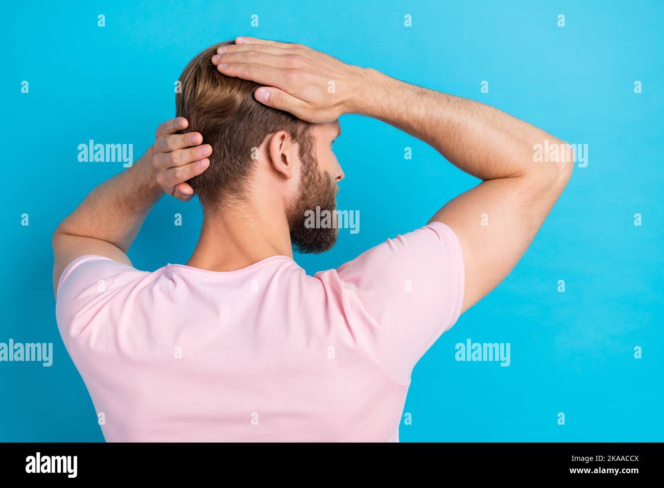 Photo portrait of handsome young guy back view touch hair hand haircut ...