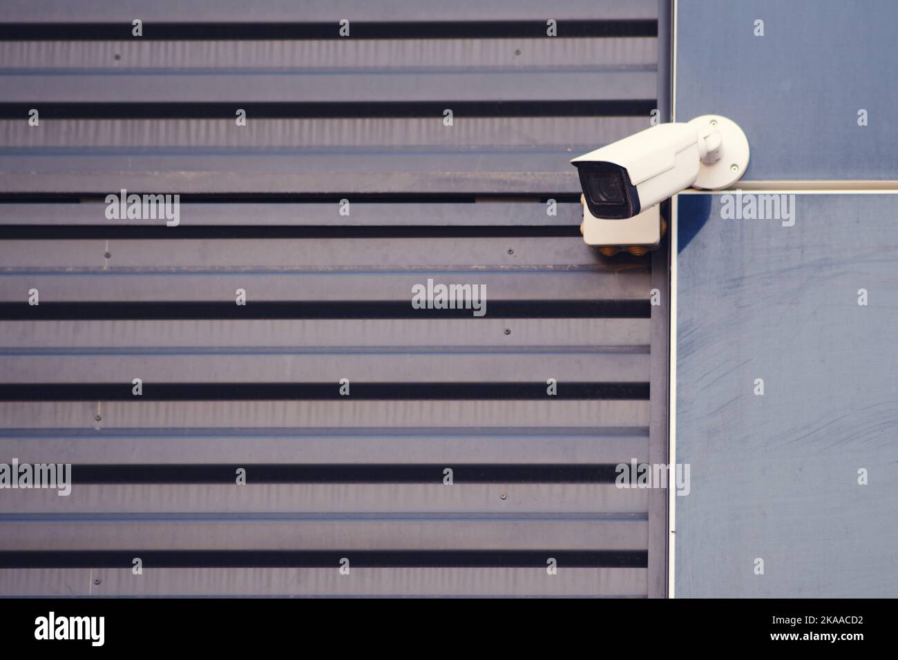 Surveillance camera at the garage door on the facade of the building ...