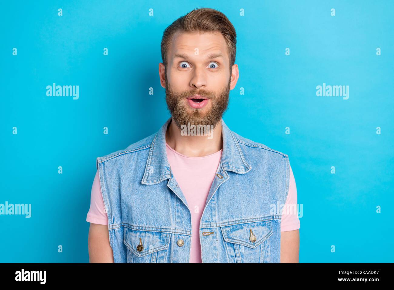 Photo of shocked impressed young guy dressed denim vest big eyes ...