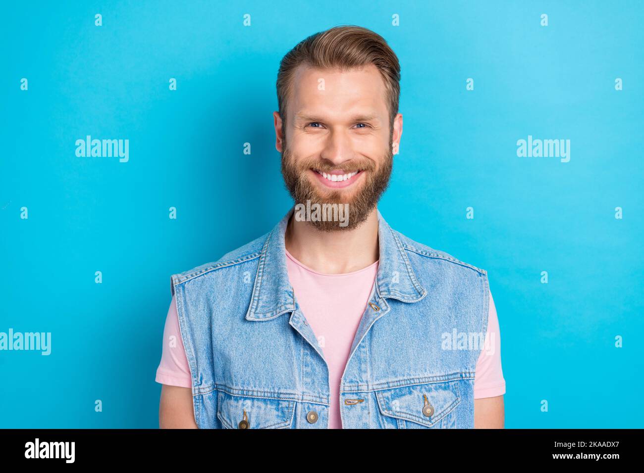 Photo of cheerful funny young guy dressed denim vest smiling white ...