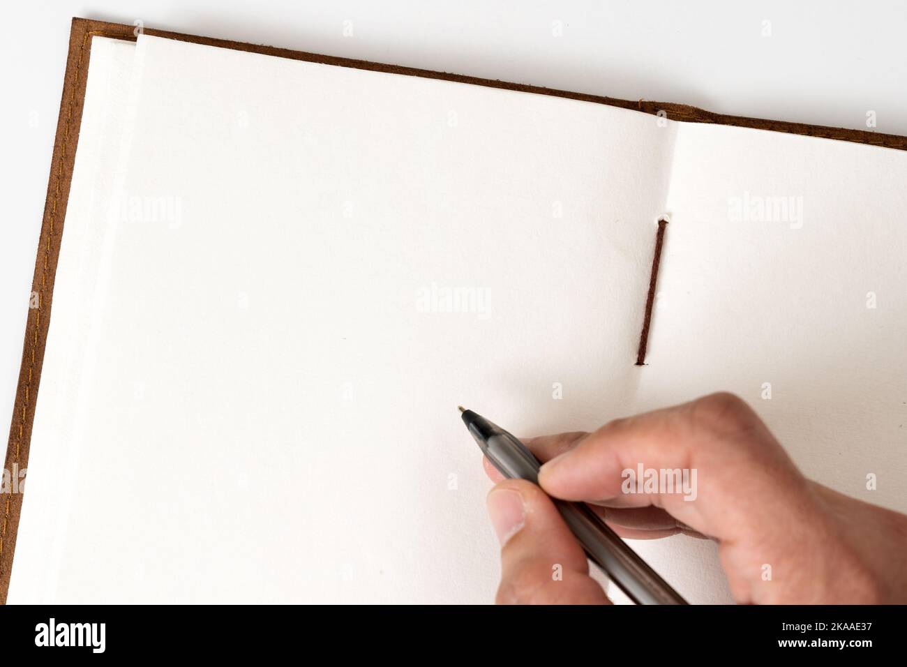 Blank notebook with hand holding pen Stock Photo - Alamy
