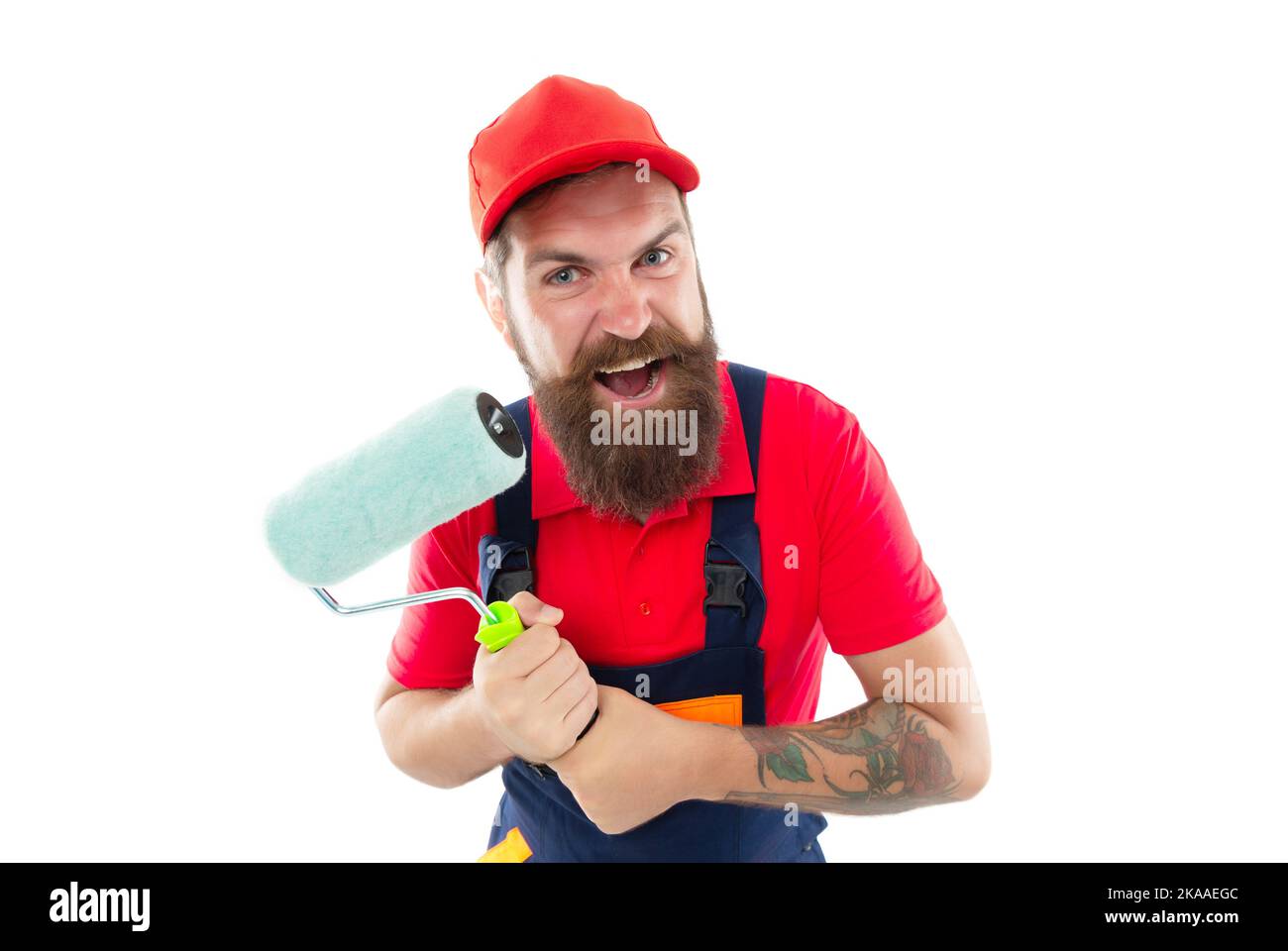angry man painter with paintroller in uniform. bearded man painter with ...