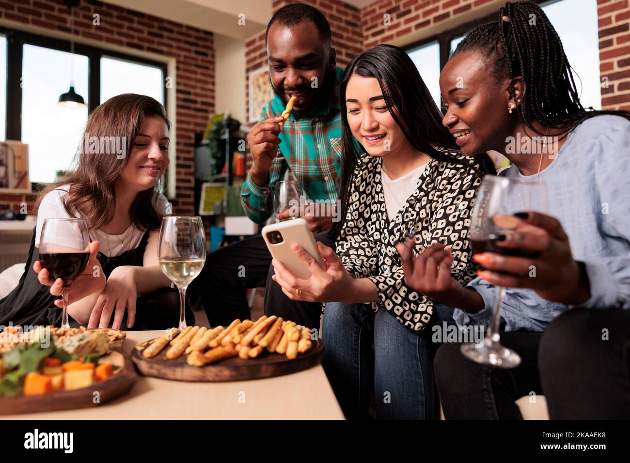 Smiling young adults, bunch people staring, looking movies at cell ...