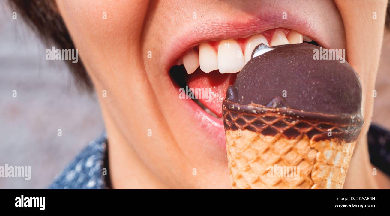 Man in blue shirt is eating ice-cream. Closeup photo of cold dessert ...