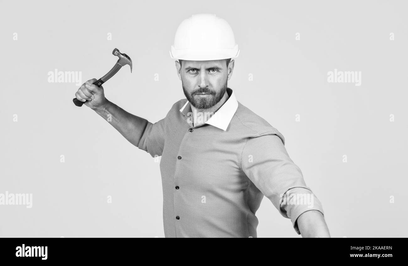business boss with beard and bristle wear hard hat hold hammer, labor ...