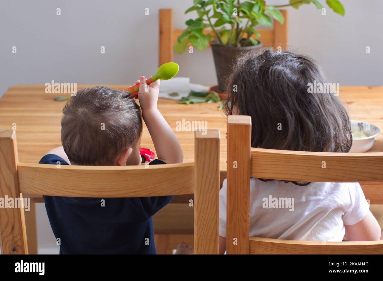 Siblings fooling around at the breakfast table Stock Photo - Alamy