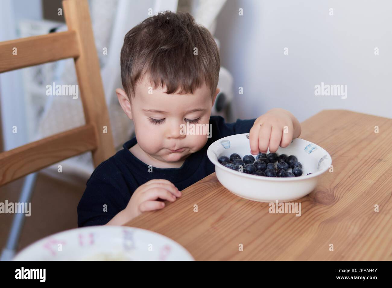 Siblings fooling around at the breakfast table Stock Photo - Alamy