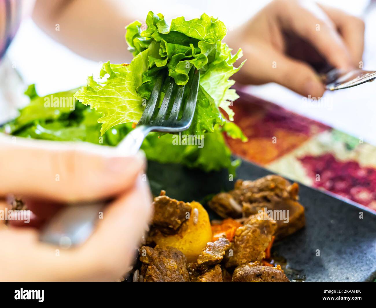 person eating vegetables and meats Stock Photo - Alamy