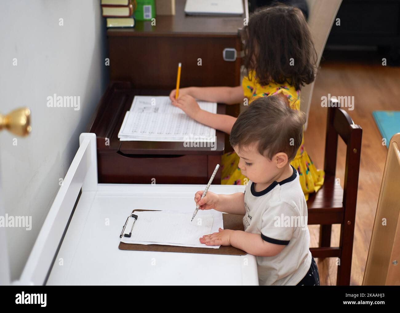 Little toddler copying his sister doing her homework Stock Photo - Alamy Little toddler copying his sister doing her homework Stock Photo - Alamy