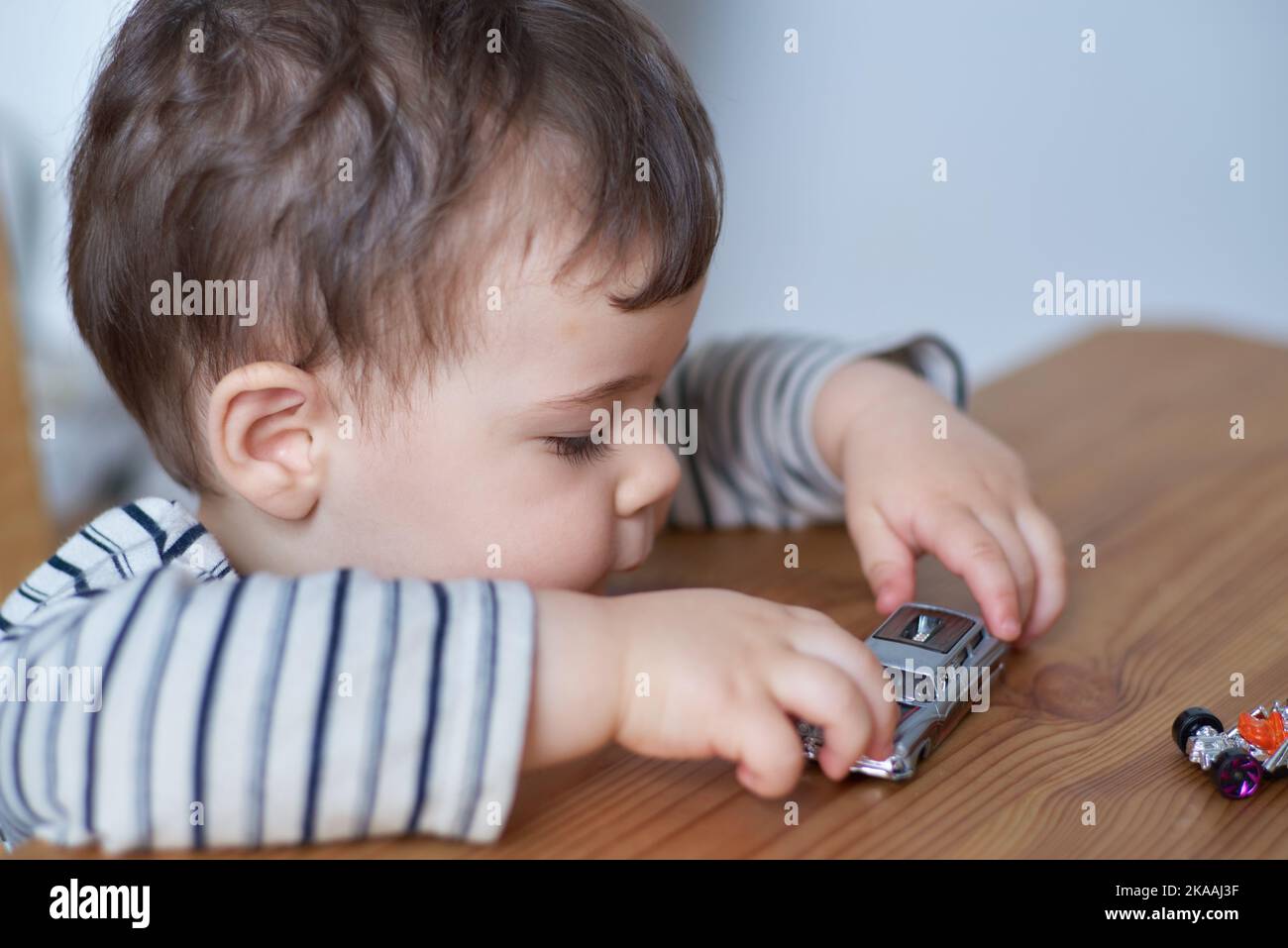 Little boy plaing with his toy cars Stock Photo - Alamy