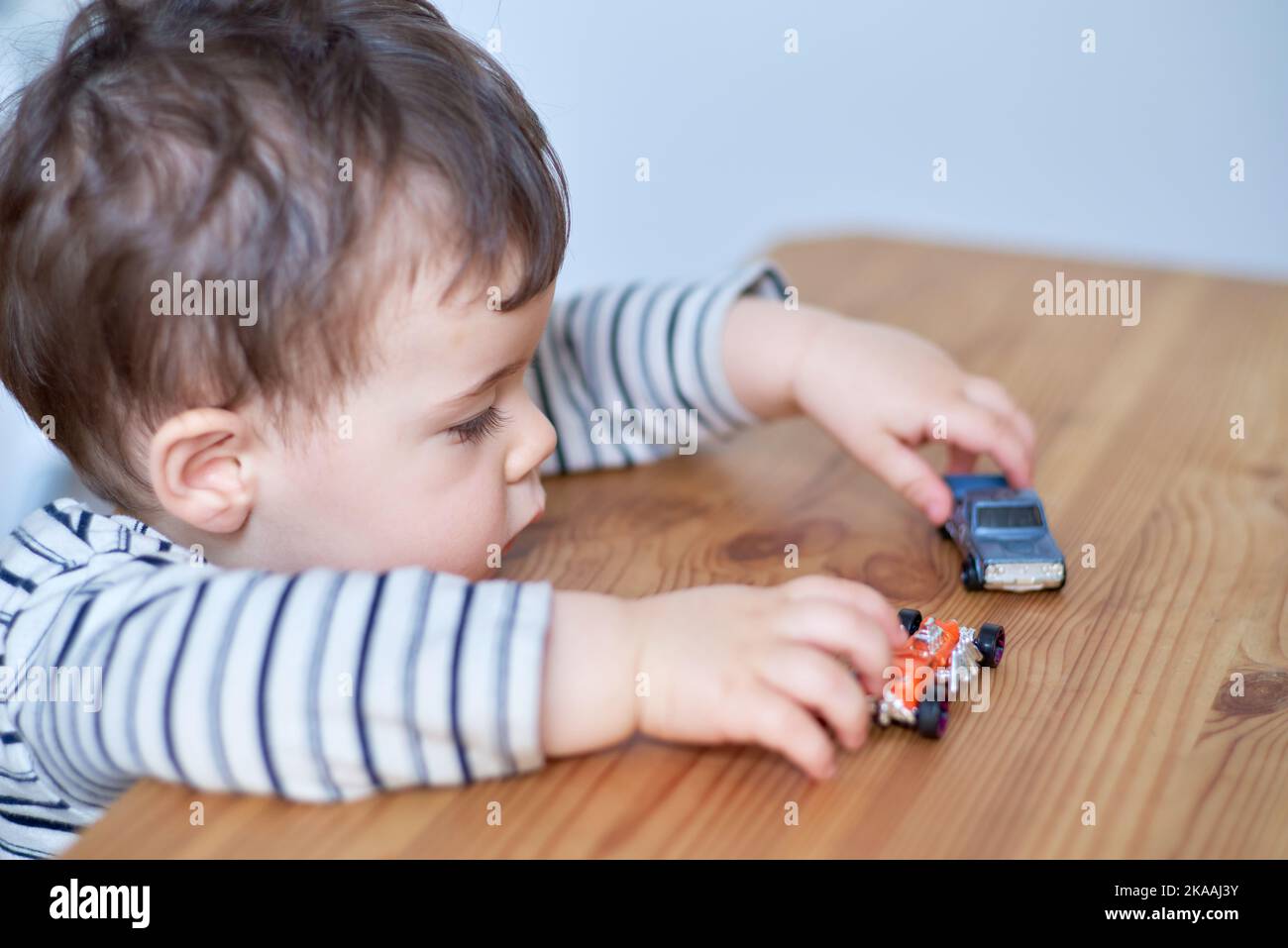 Little boy plaing with his toy cars Stock Photo - Alamy