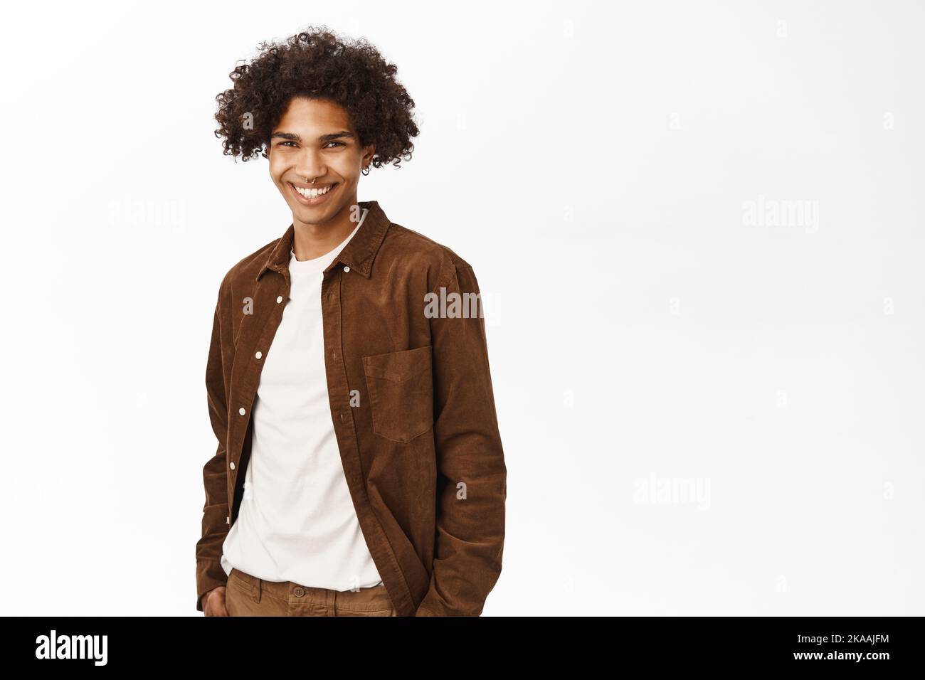 Portrait of smiling hispanic man with confident face, holding hands in ...