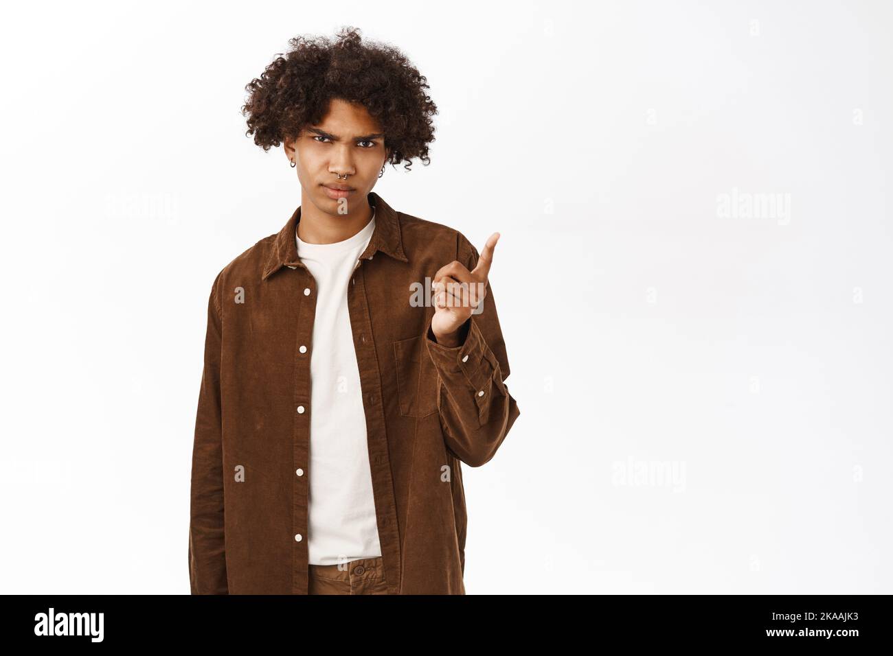 Portrait of upset young man shaking finger and frowning, disapprove ...