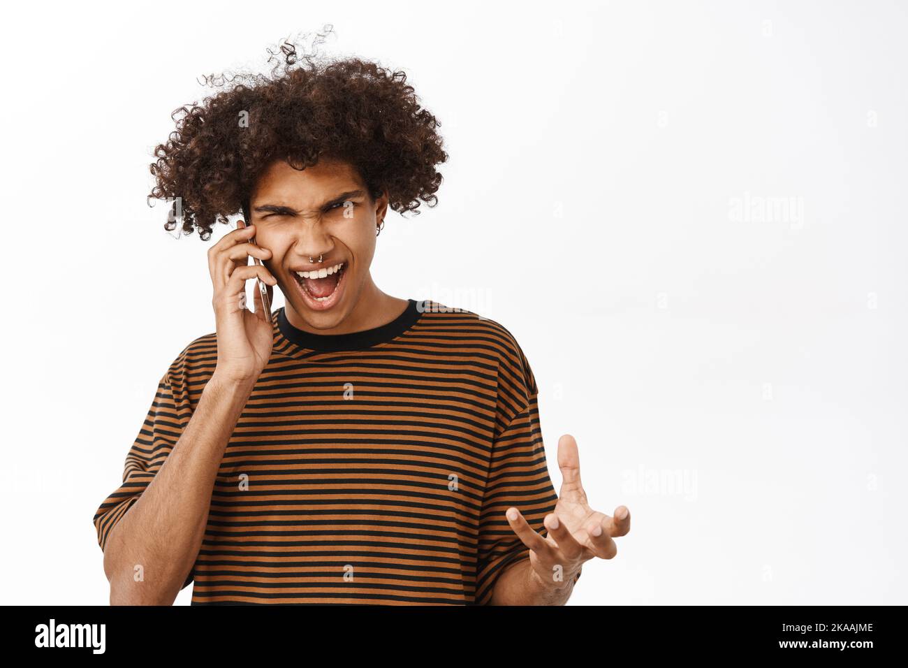 Close up of young gen z guy laughing and talking on phone, calling on ...