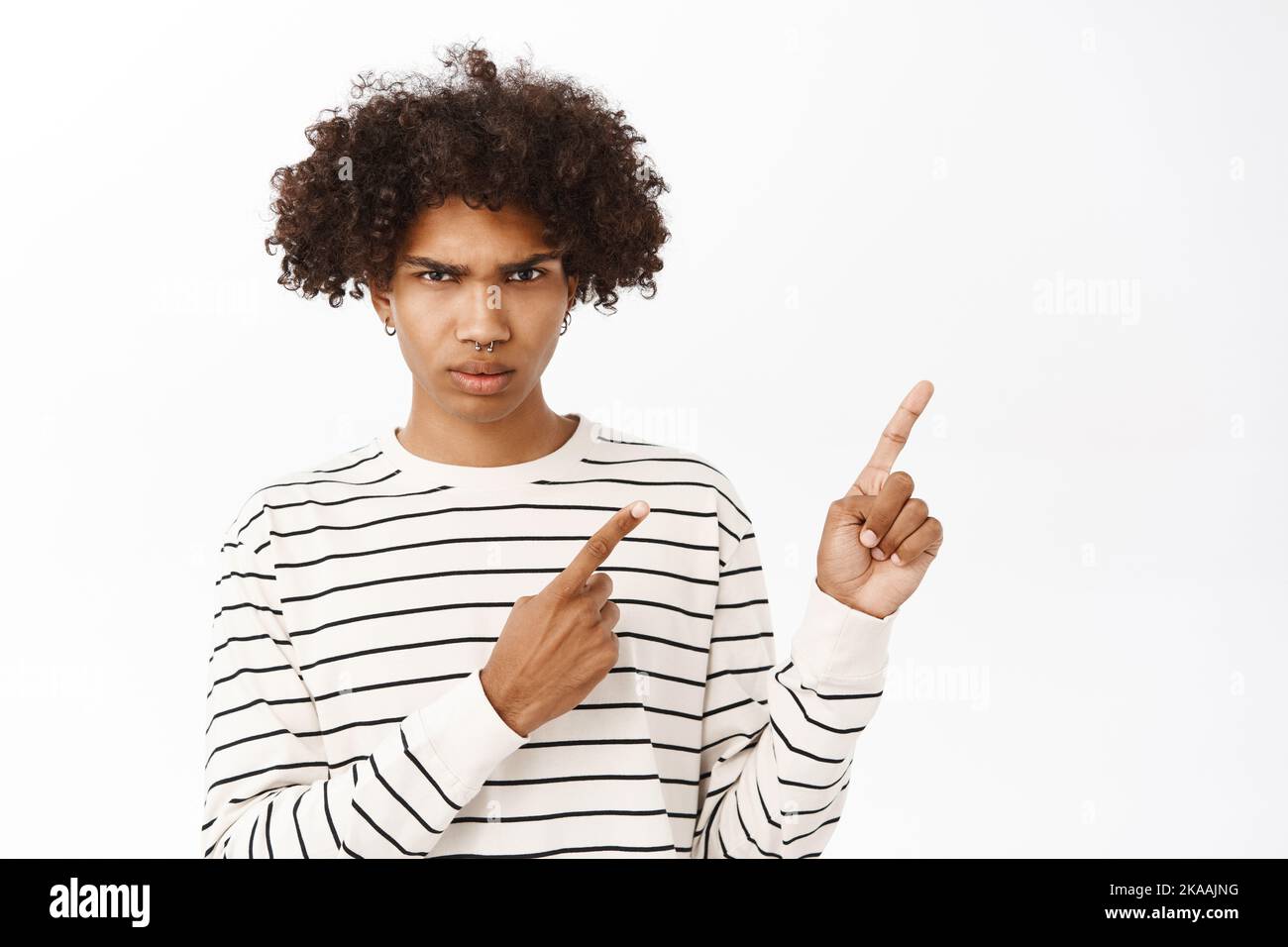Frustrated hispanic guy, pointing fingers right, showing banner with ...