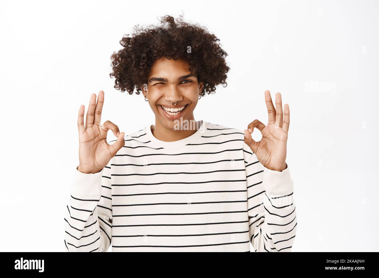 Close up of handsome young boy, teenage guy showing okay, ok sign ...