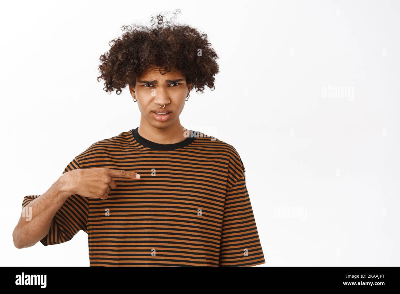 Who me. Confused hispanic guy pointing at himself with clueless face ...